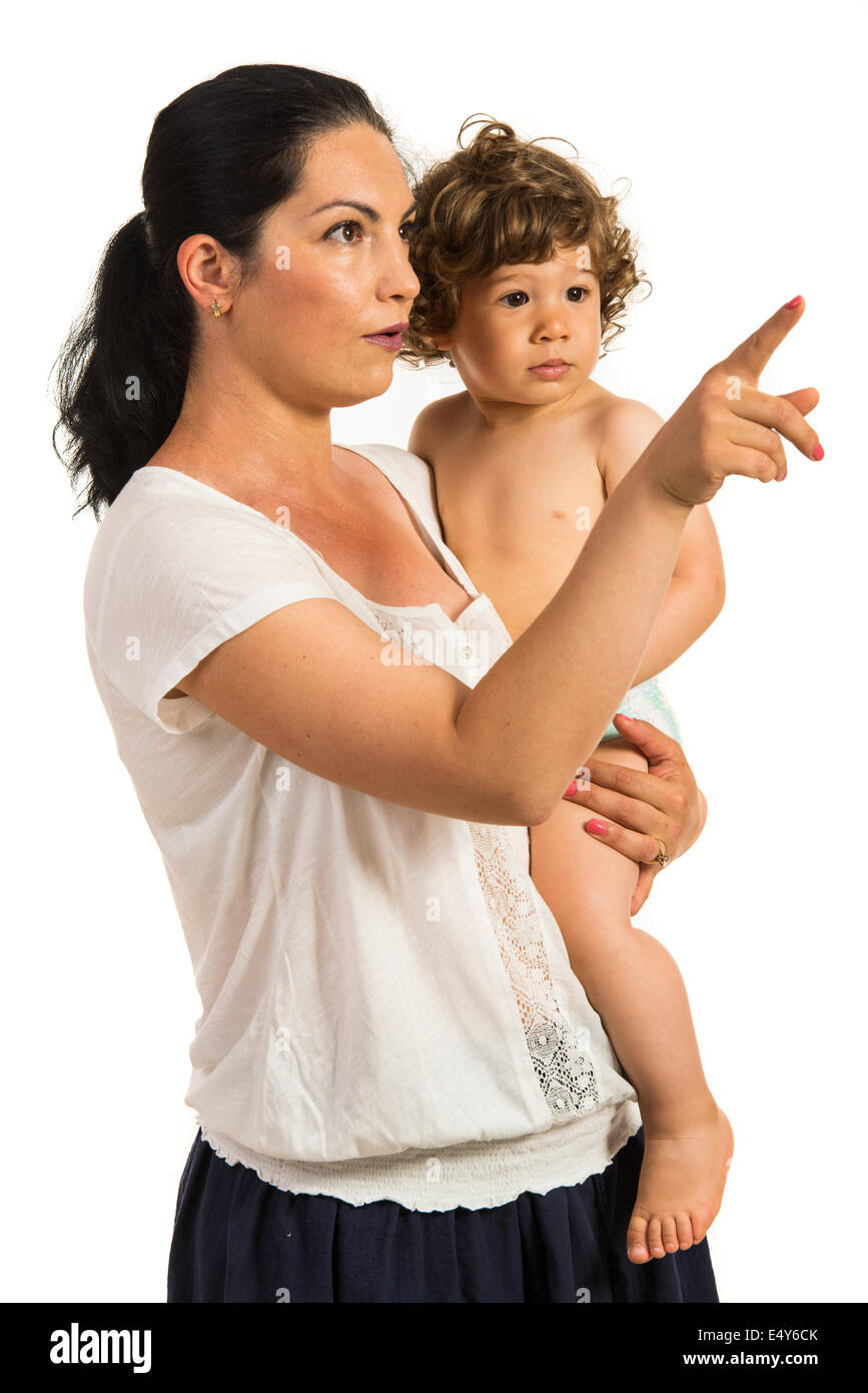 Mother pointing away and showing something to her toddler son isolated ...