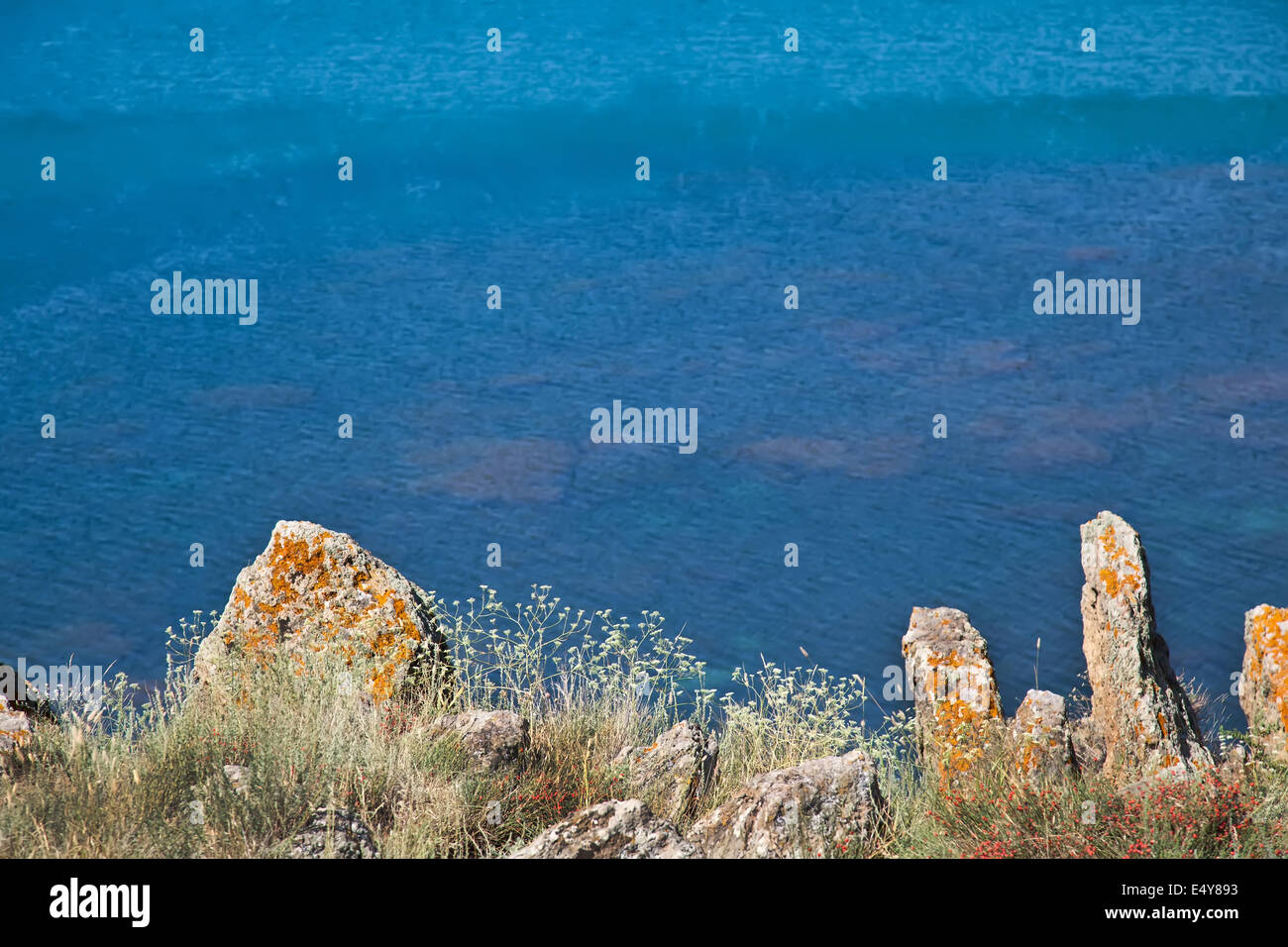 Black sea water through stones Stock Photo - Alamy