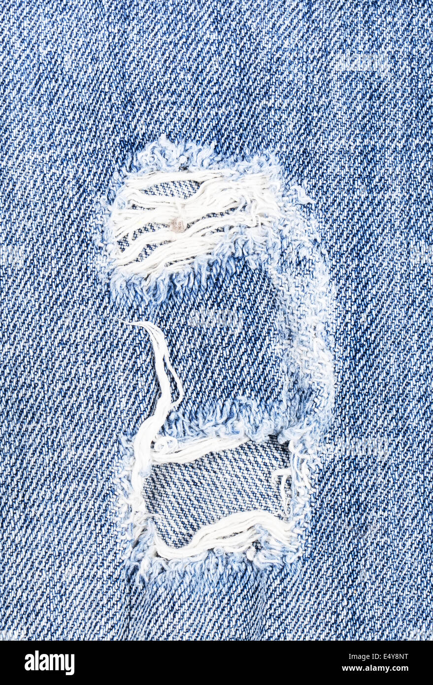 Beautiful hole in jeans textile Stock Photo - Alamy