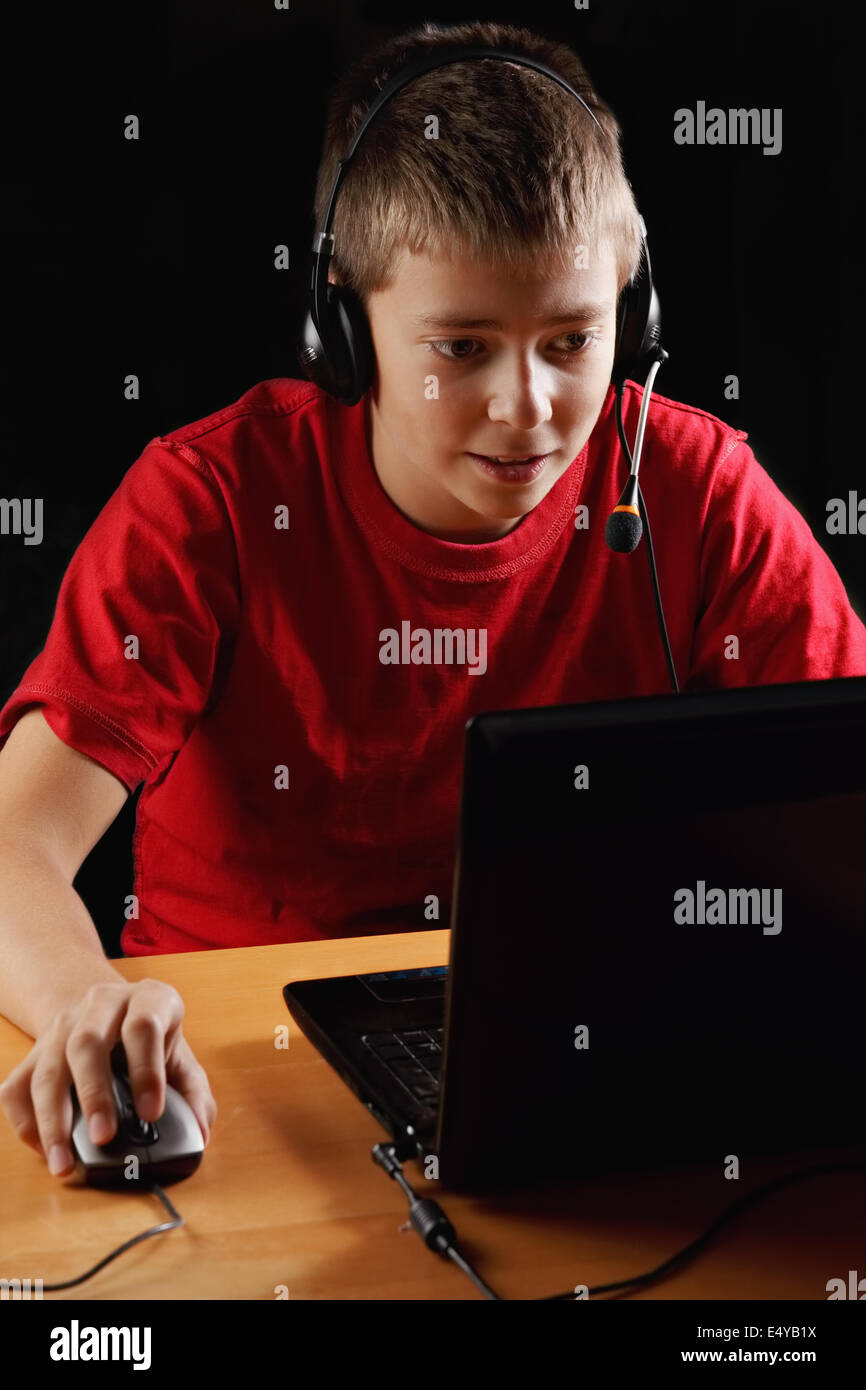 Teenager playing on laptop Stock Photo - Alamy