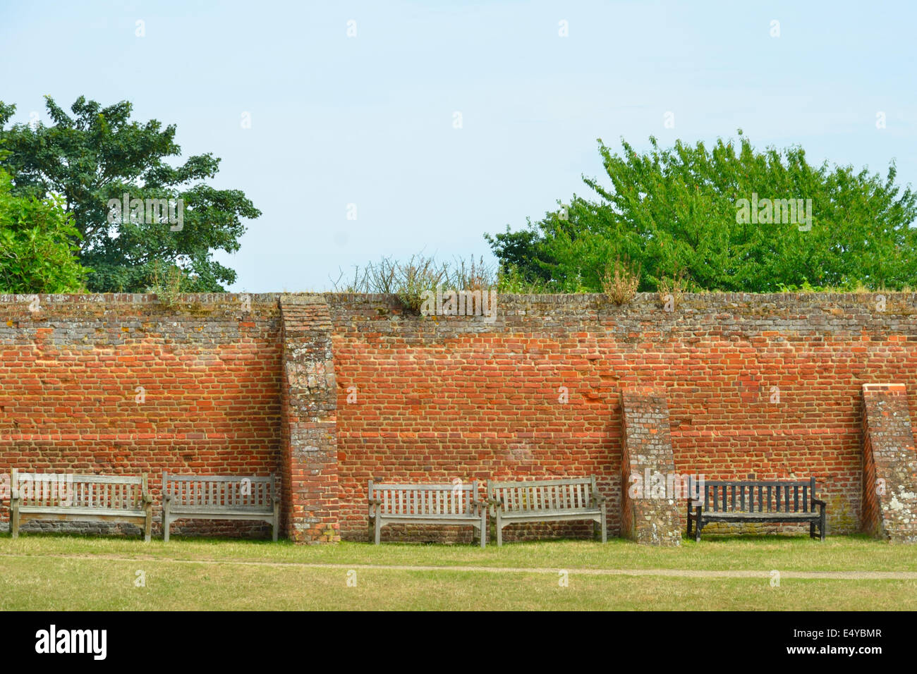 Benches against brick wall Stock Photo - Alamy