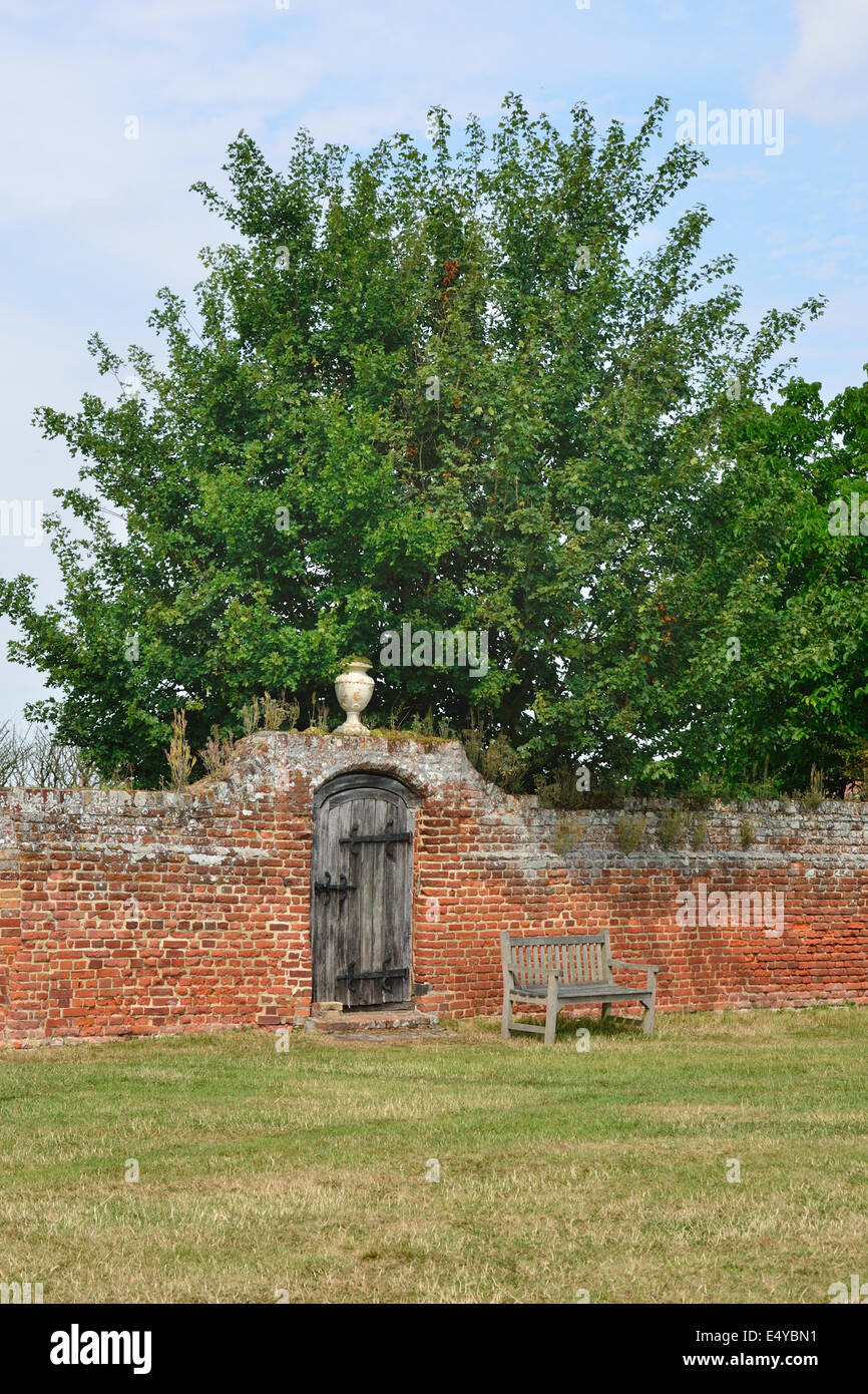 Garden wall with gate Stock Photo - Alamy
