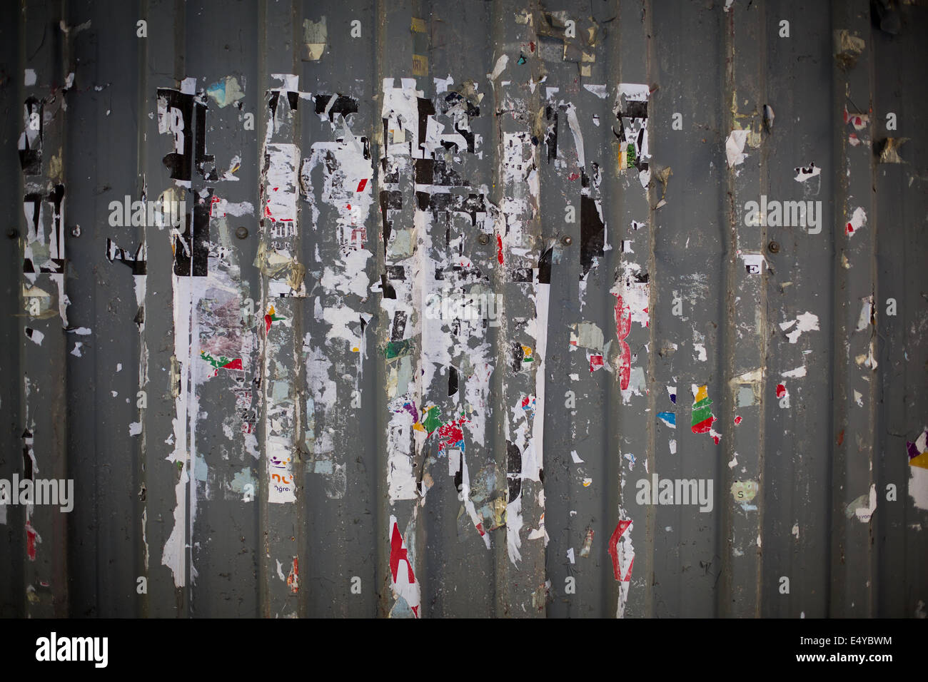 Metal wall with pieces of posters Stock Photo - Alamy