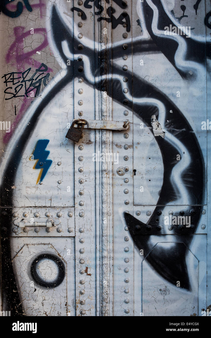 Graffiti on metal doors with lock Stock Photo - Alamy