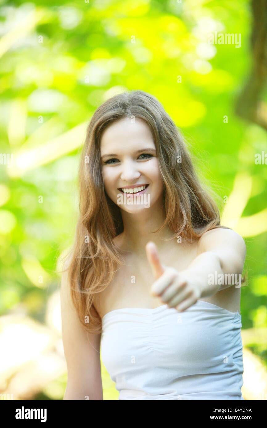 Happy young woman giving a thumbs up Stock Photo - Alamy Happy young woman giving a thumbs up Stock Photo - Alamy