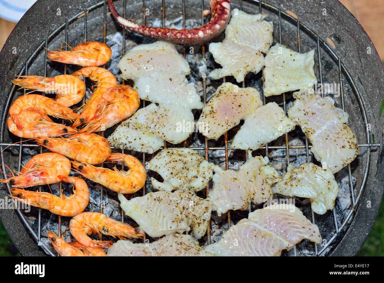 Grilled seafood on the barbecue Stock Photo - Alamy