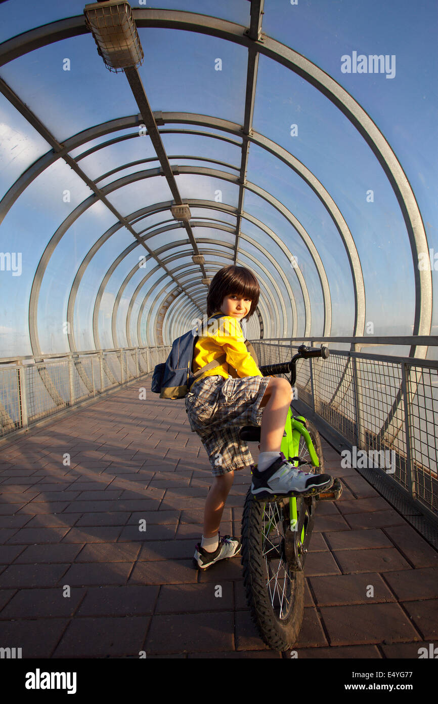 boy on a bicycle in the covered bridge Stock Photo - Alamy