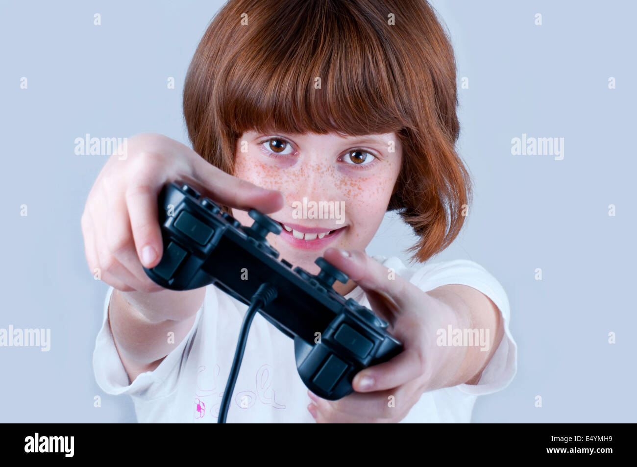 Picture of a young with freckles playing games Stock Photo - Alamy