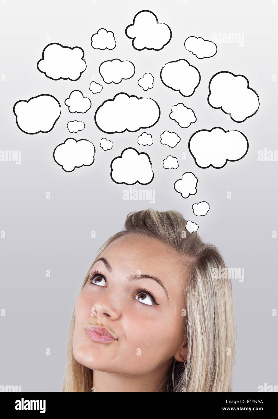 Young girl thinking with clouds Stock Photo - Alamy