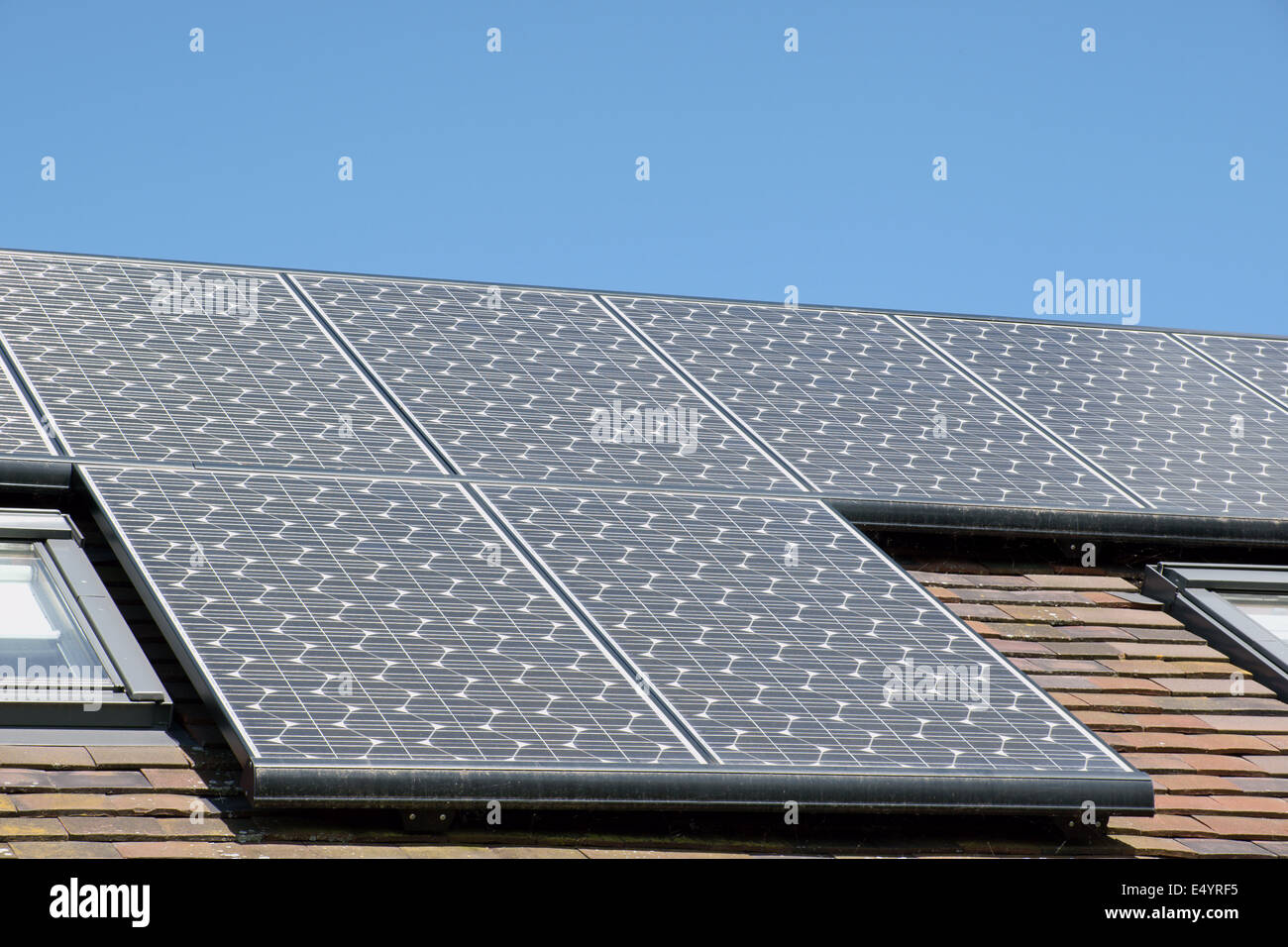 Solar Panels on a roof against an azure blue sky Stock Photo - Alamy