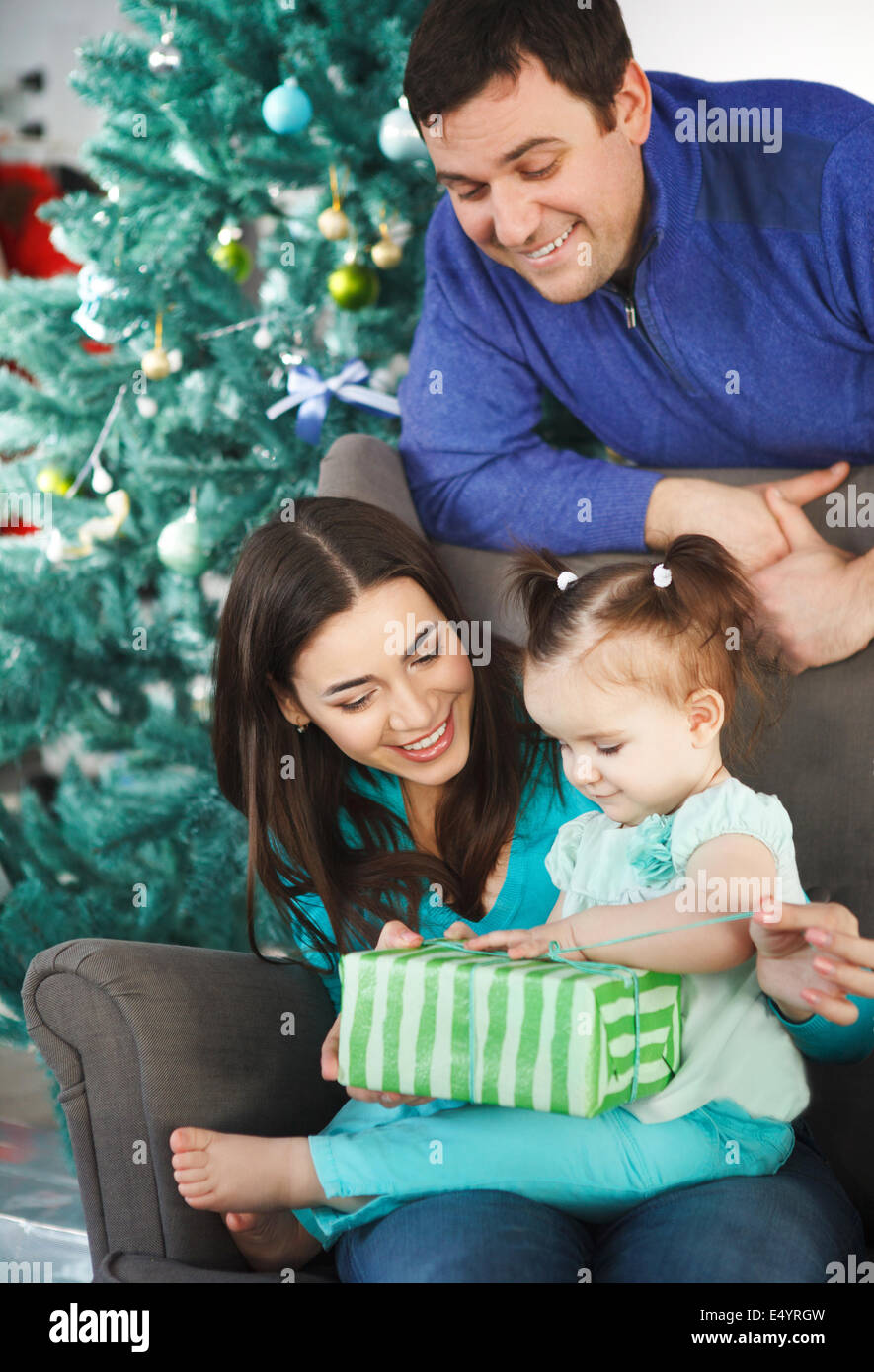 Happy family with Christmas present Stock Photo - Alamy