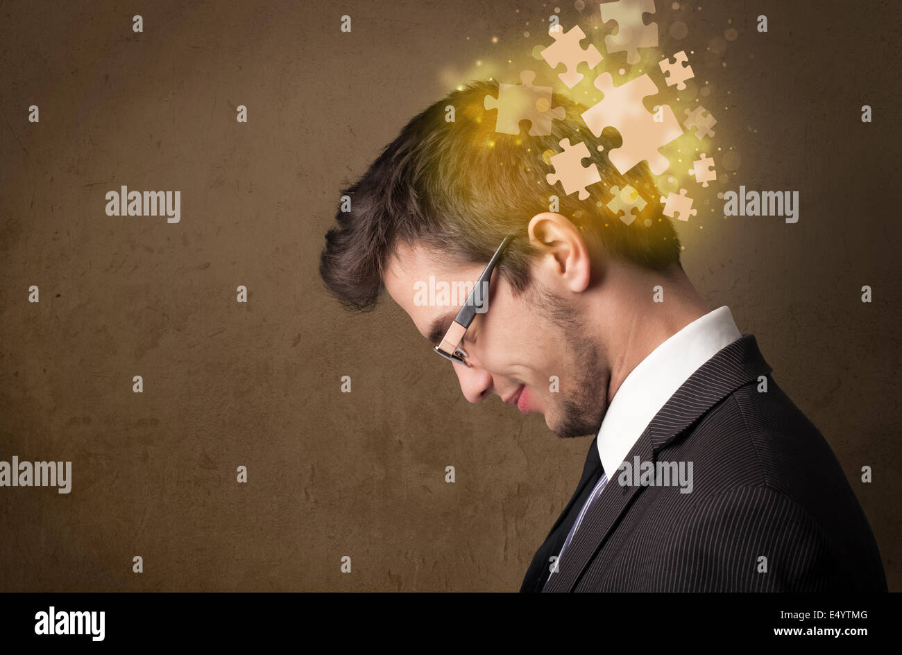 Young person thinking with glowing puzzle mind Stock Photo - Alamy