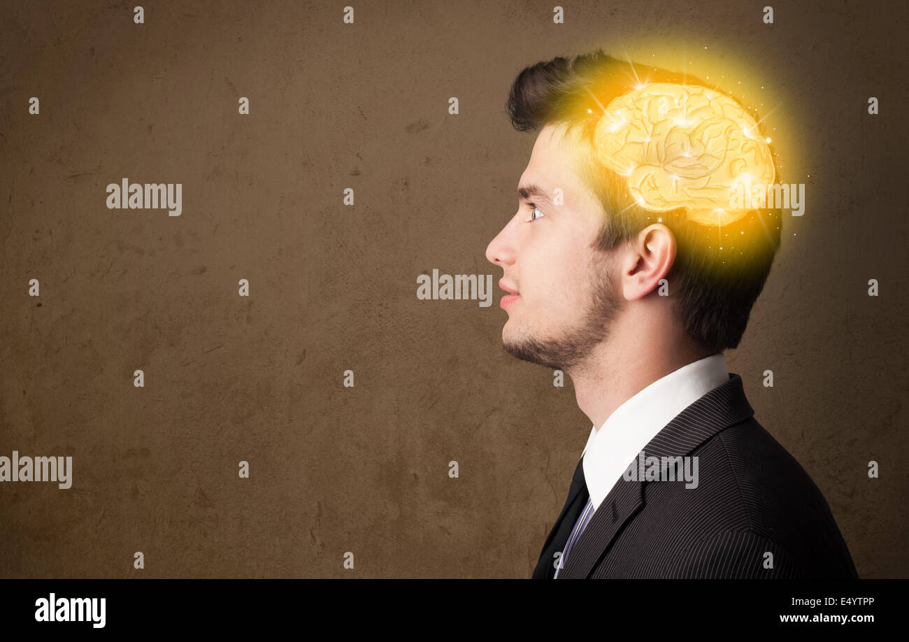 Young man thinking with glowing brain illustration Stock Photo - Alamy