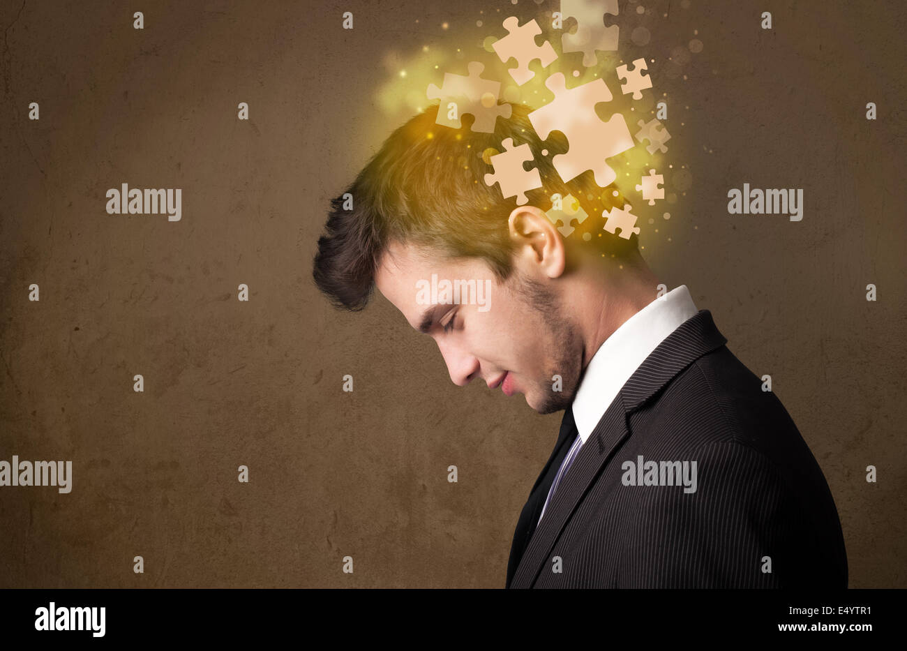 Young person thinking with glowing puzzle mind Stock Photo - Alamy