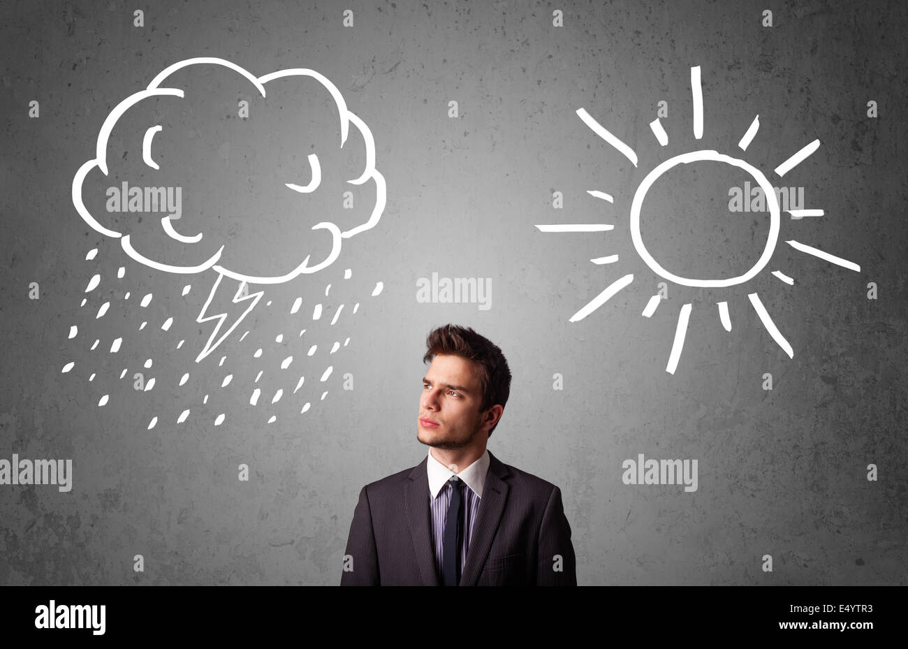 Businessman standing between a sun and a rain drawing Stock Photo - Alamy