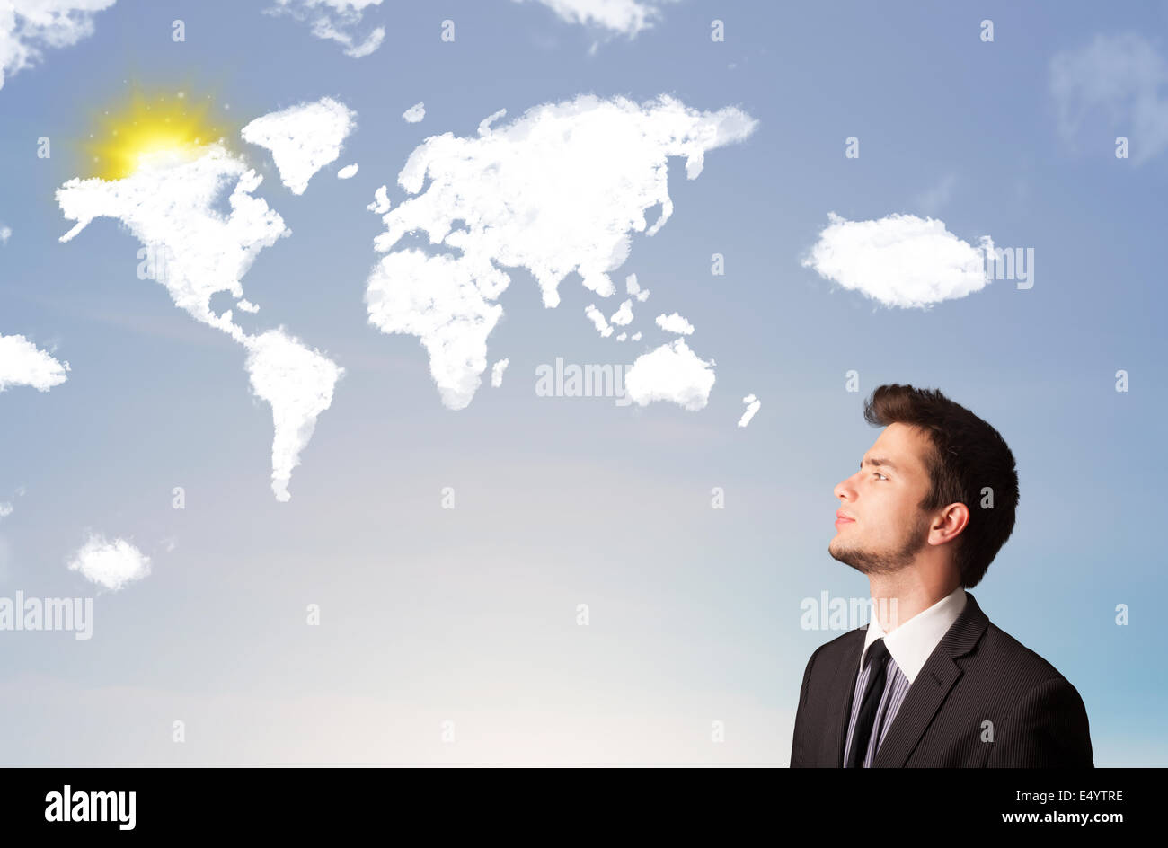 Businessman looking at world clouds and sun on blue sky Stock Photo - Alamy
