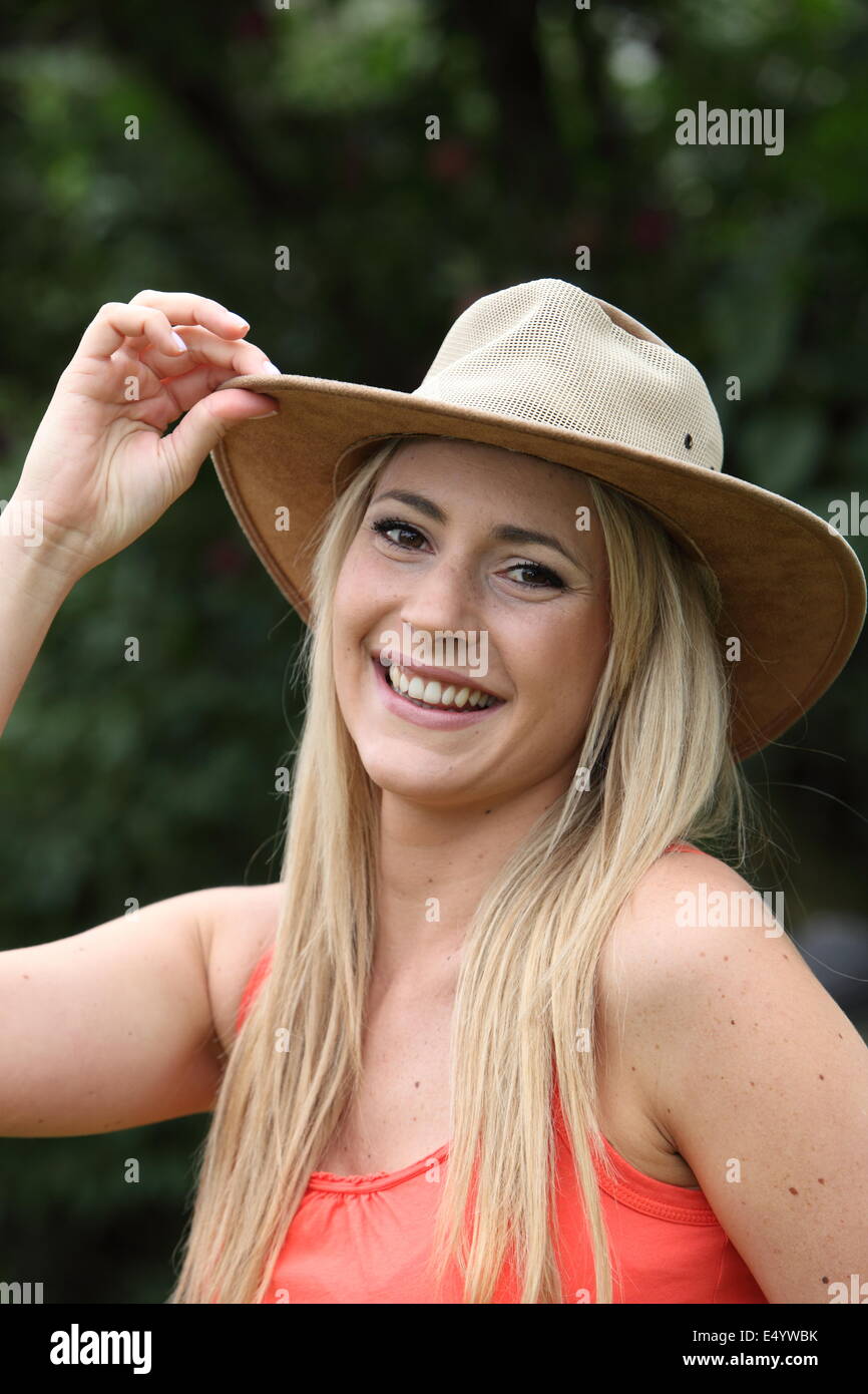 Vivacious young woman in a trendy hat Stock Photo - Alamy