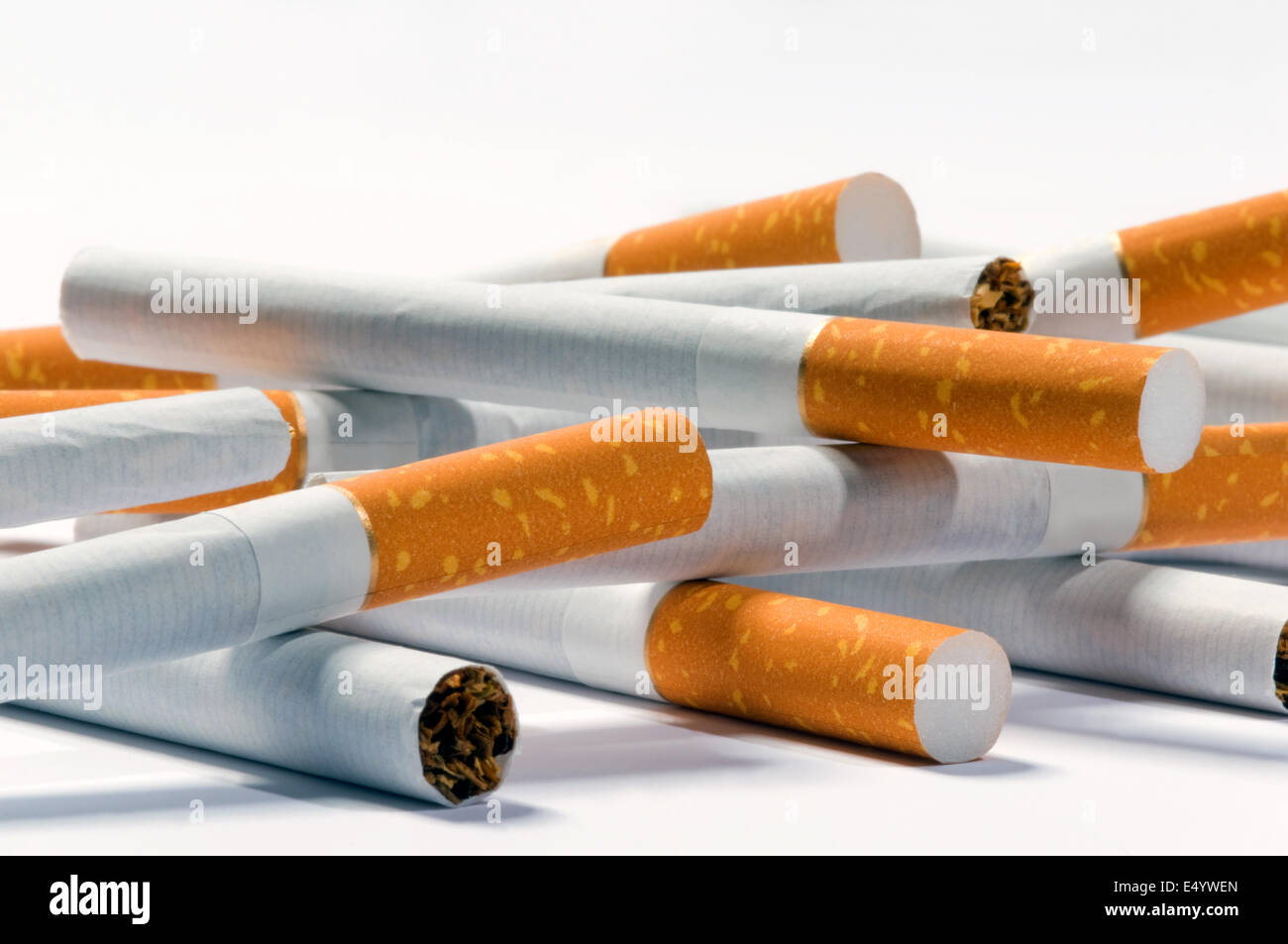 cigarettes lying on a white background Stock Photo - Alamy