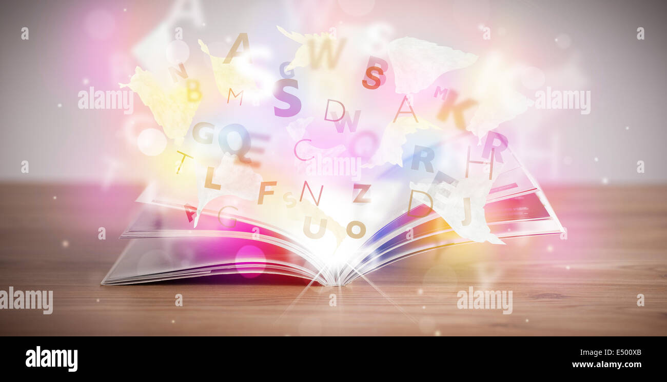 Open book with glowing letters on concrete background Stock Photo - Alamy