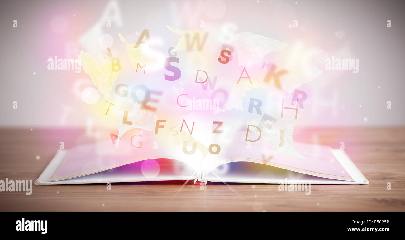 Open book with glowing letters on concrete background Stock Photo - Alamy