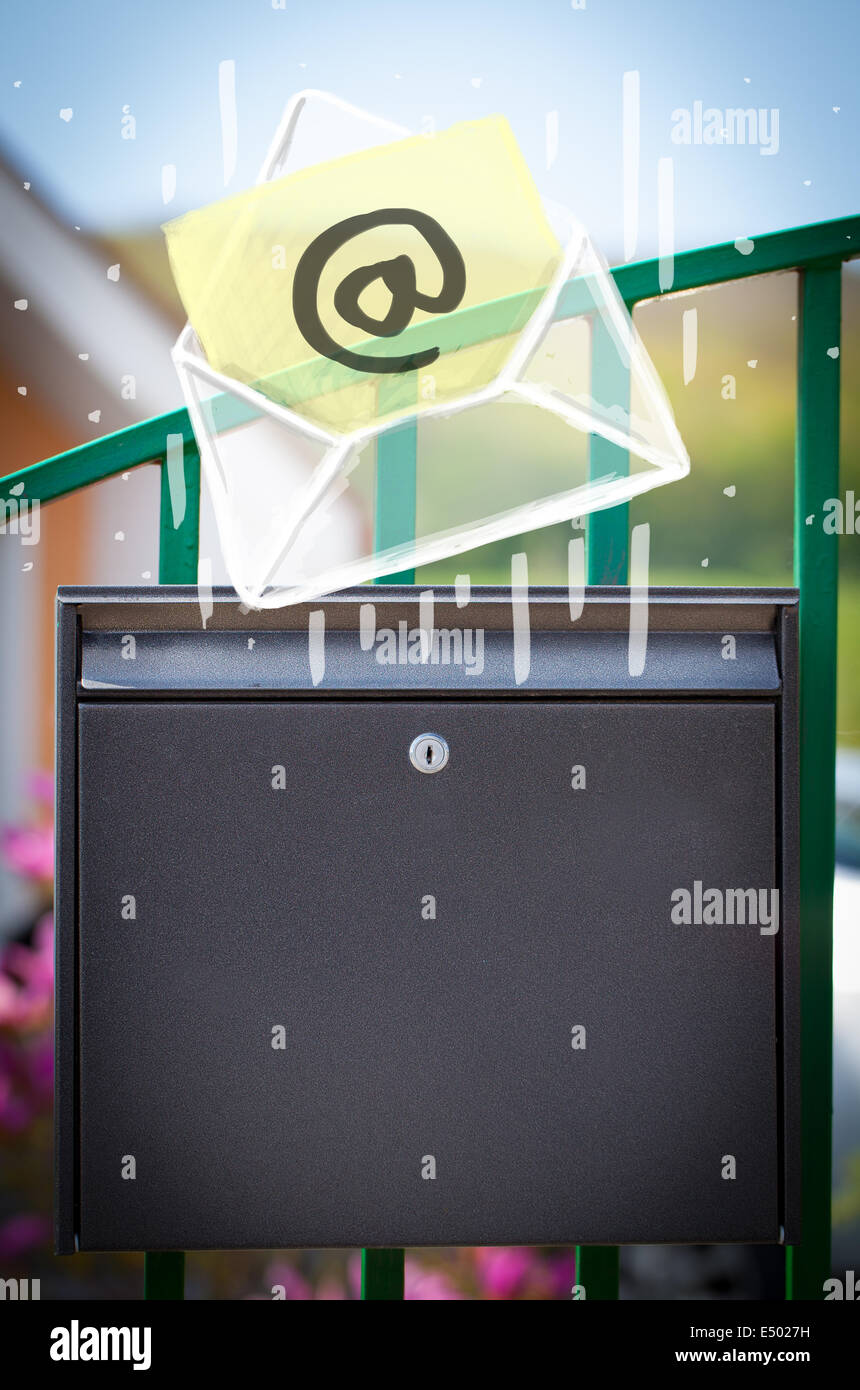 Envelope with email sign dropping into mailbox Stock Photo - Alamy