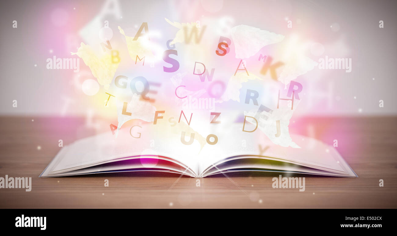 Open book with glowing letters on concrete background Stock Photo - Alamy