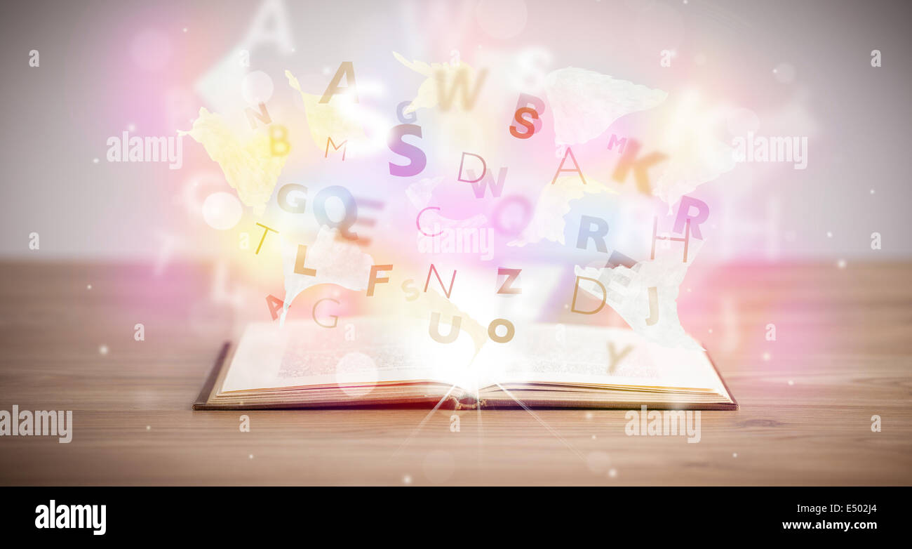 Open book with glowing letters on concrete background Stock Photo - Alamy