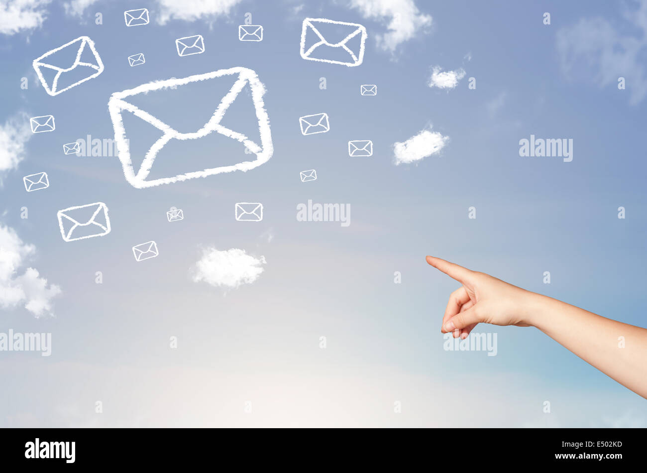 Hand pointing at mail symbol clouds on blue sky Stock Photo - Alamy