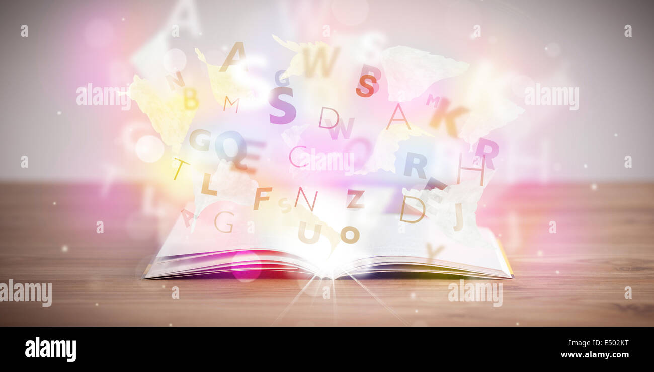 Open book with glowing letters on concrete background Stock Photo - Alamy