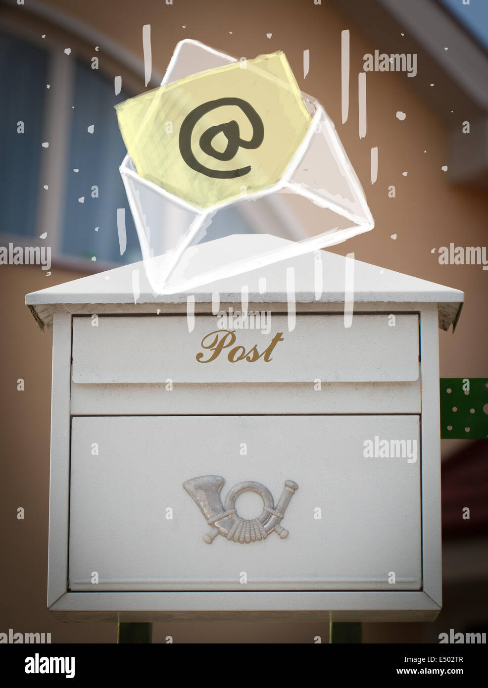 Envelope with email sign dropping into mailbox Stock Photo - Alamy