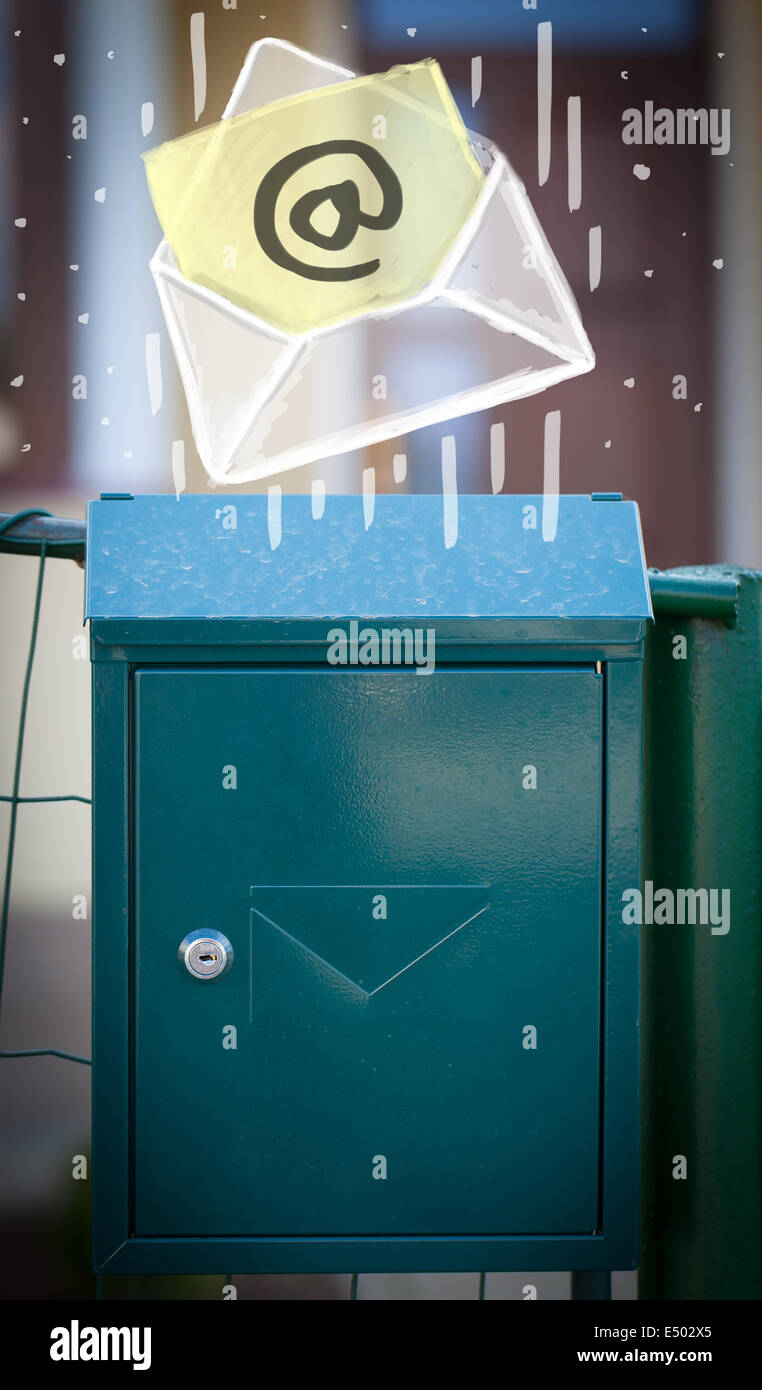 Envelope with email sign dropping into mailbox Stock Photo - Alamy