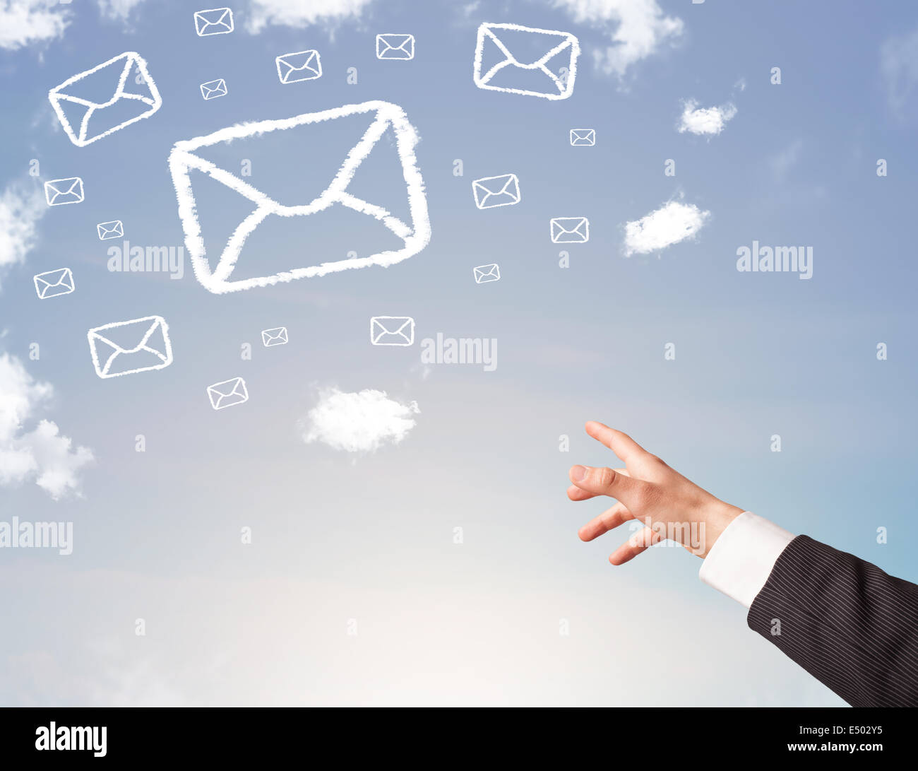 Hand pointing at mail symbol clouds on blue sky Stock Photo - Alamy