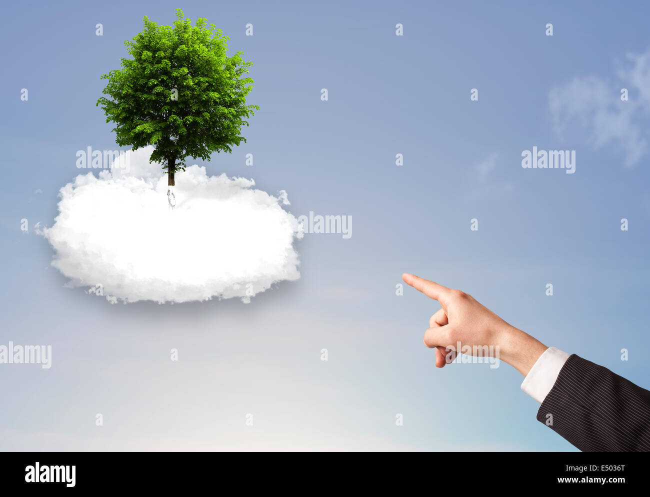 Hand pointing at a green tree on top of a white cloud Stock Photo - Alamy