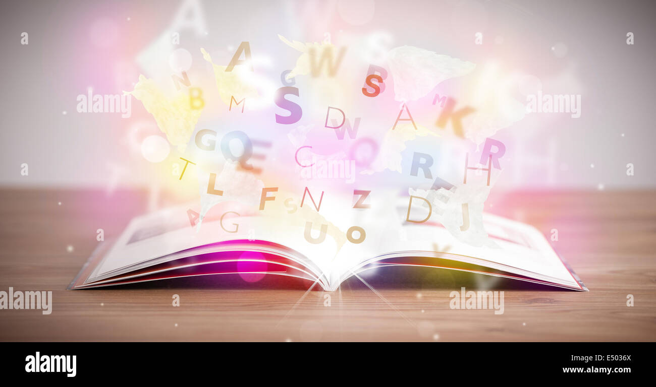 Open book with glowing letters on concrete background Stock Photo - Alamy