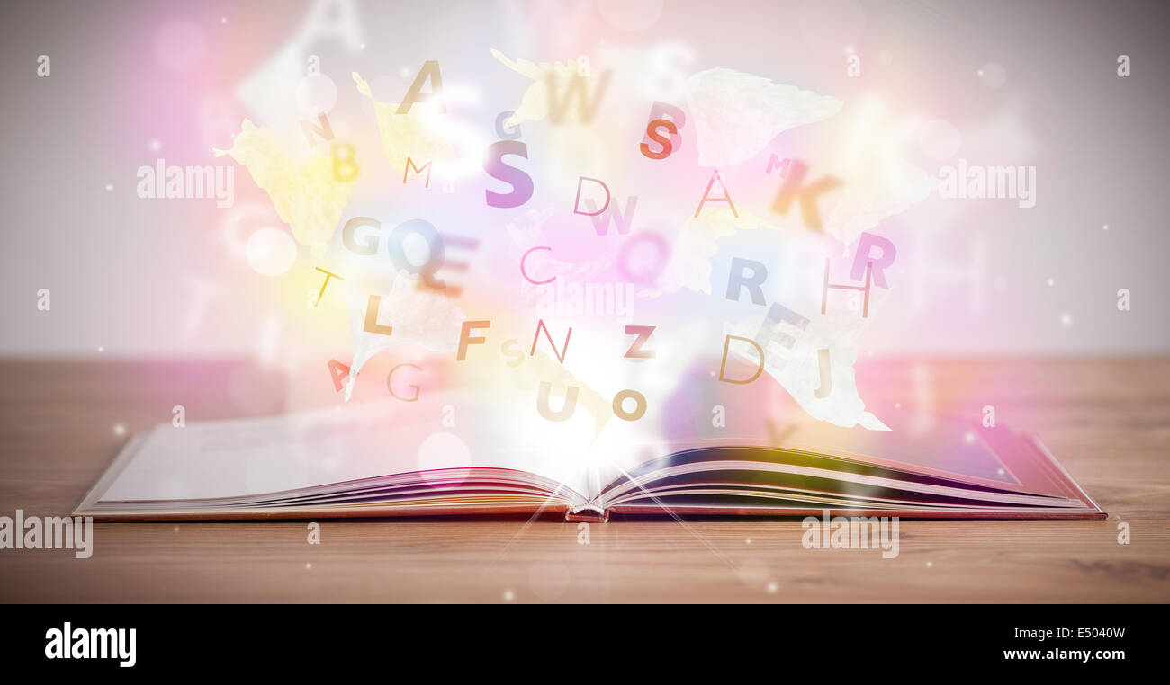 Open book with glowing letters on concrete background Stock Photo - Alamy