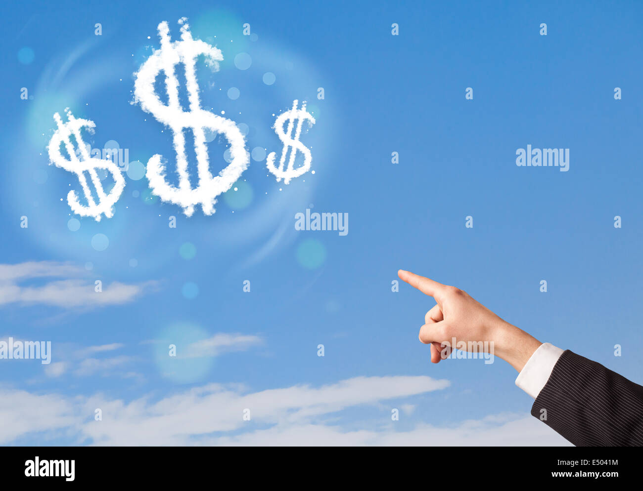 Hand pointing at dollar sign clouds on blue sky Stock Photo - Alamy