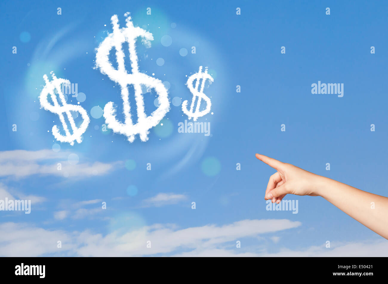 Hand pointing at dollar sign clouds on blue sky Stock Photo - Alamy