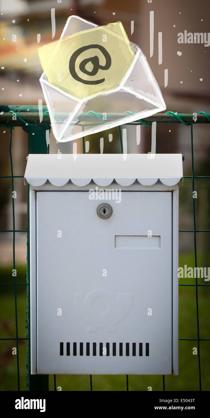 Envelope with email sign dropping into mailbox Stock Photo - Alamy