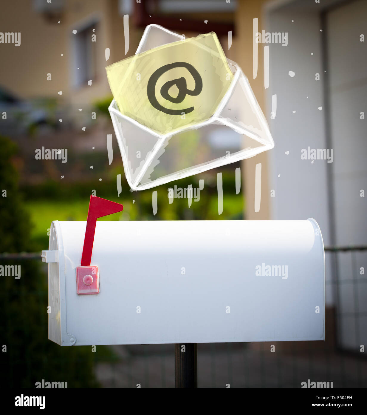 Envelope with email sign dropping into mailbox Stock Photo - Alamy