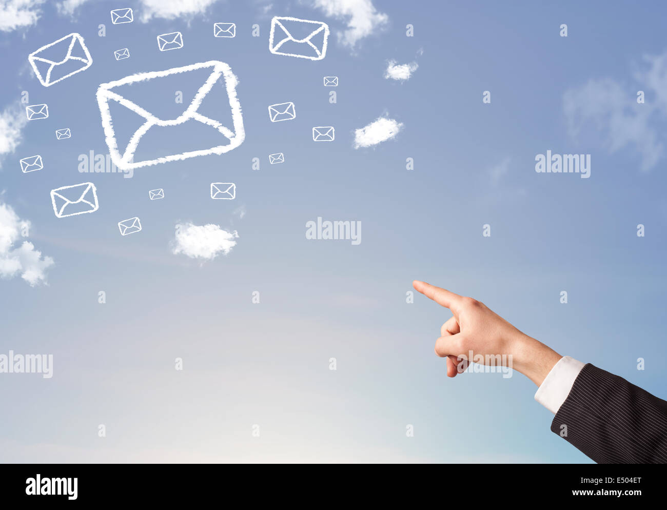 Hand pointing at mail symbol clouds on blue sky Stock Photo - Alamy
