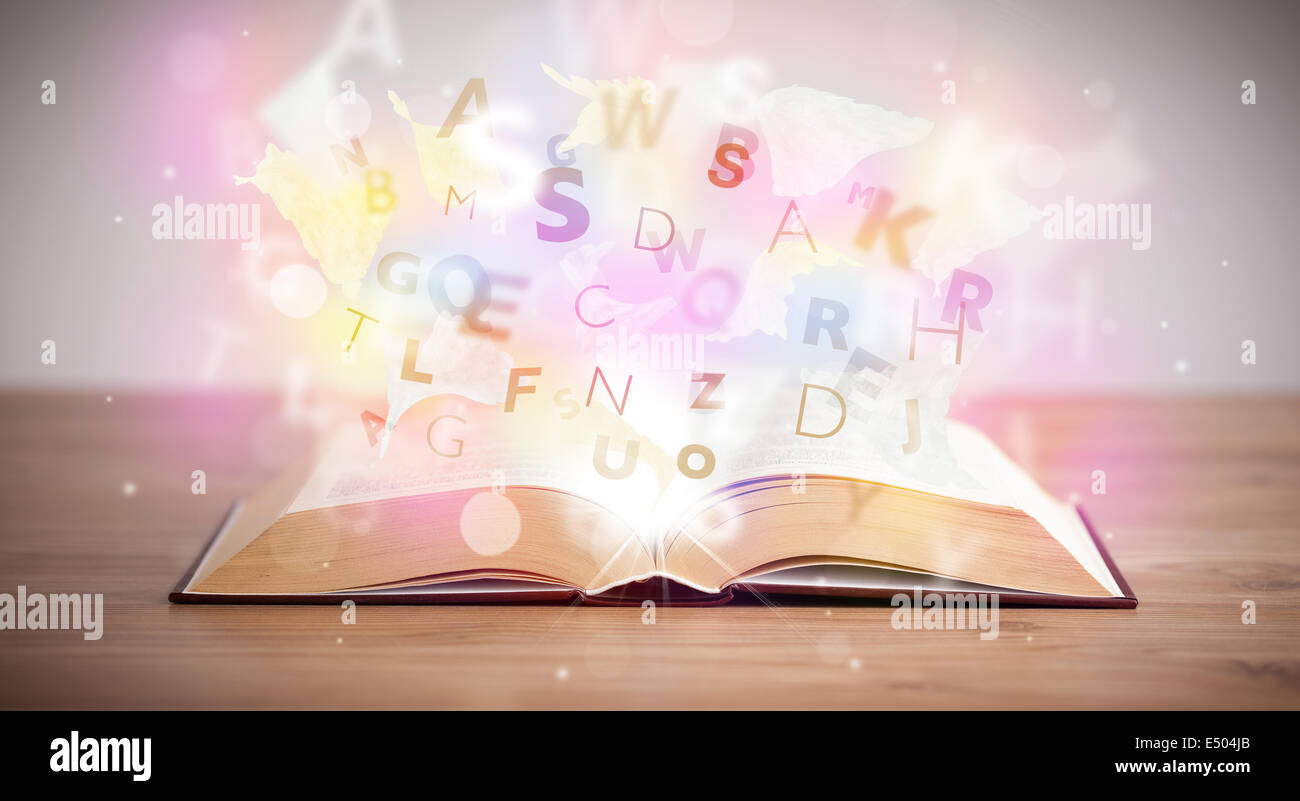 Open book with glowing letters on concrete background Stock Photo - Alamy