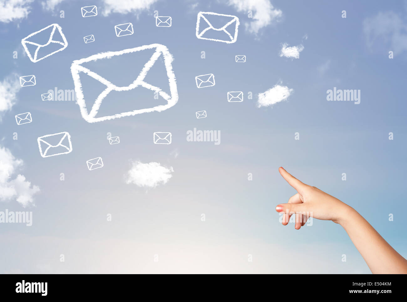Hand pointing at mail symbol clouds on blue sky Stock Photo - Alamy