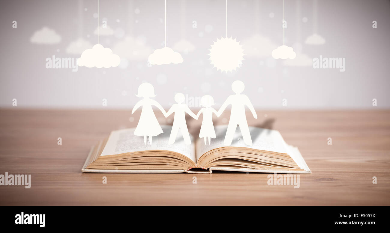 Cardboard figures of the family on opened book Stock Photo - Alamy