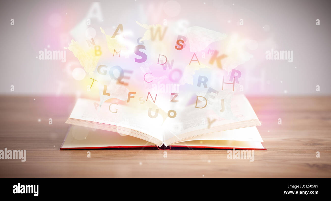 Open book with glowing letters on concrete background Stock Photo - Alamy