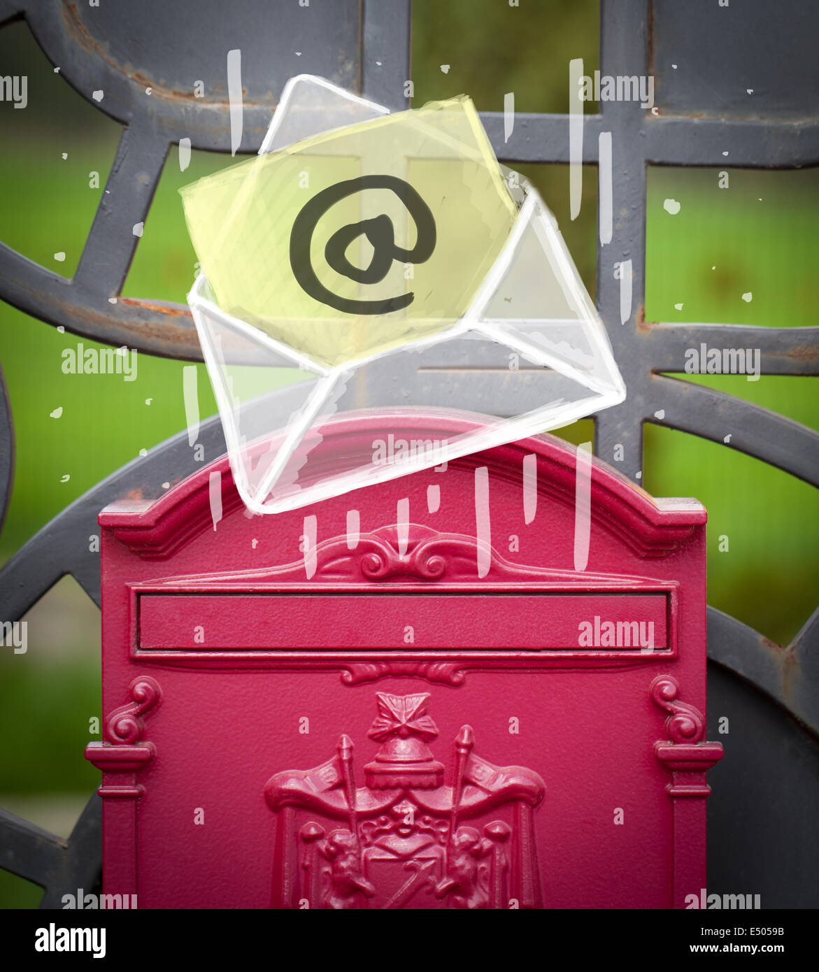 Envelope with email sign dropping into mailbox Stock Photo - Alamy