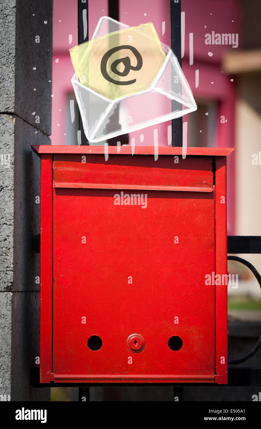 Envelope with email sign dropping into mailbox Stock Photo - Alamy