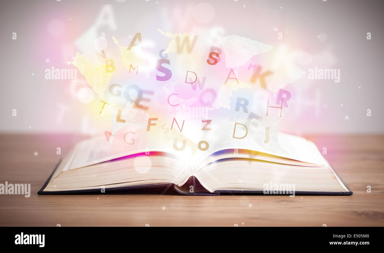 Open book with glowing letters on concrete background Stock Photo - Alamy
