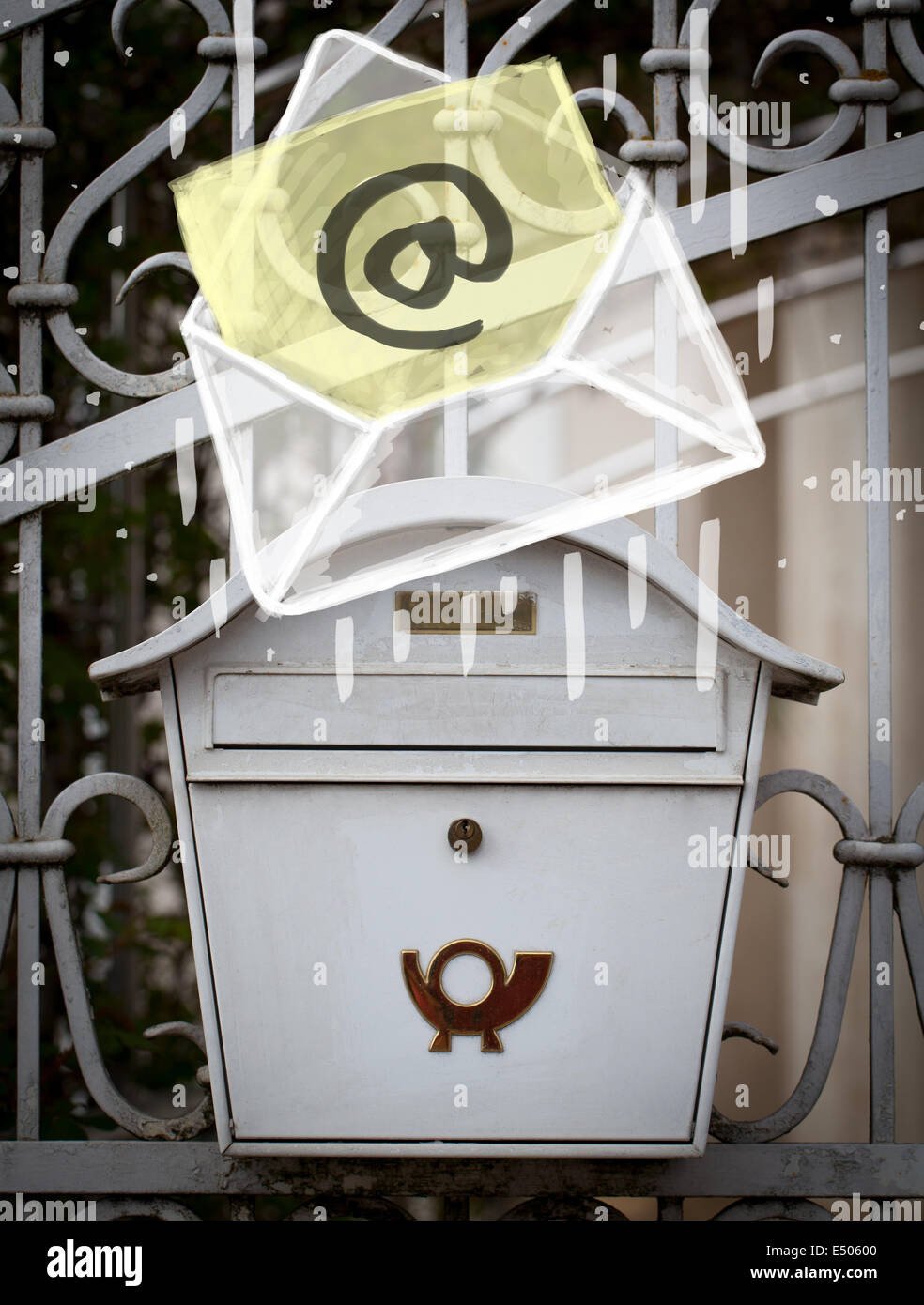 Envelope with email sign dropping into mailbox Stock Photo - Alamy