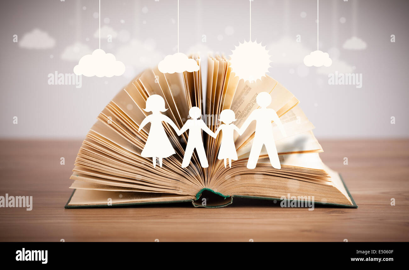 Cardboard figures of the family on opened book Stock Photo - Alamy