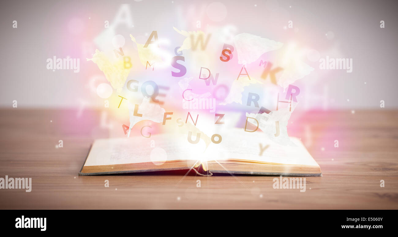 Open book with glowing letters on concrete background Stock Photo - Alamy